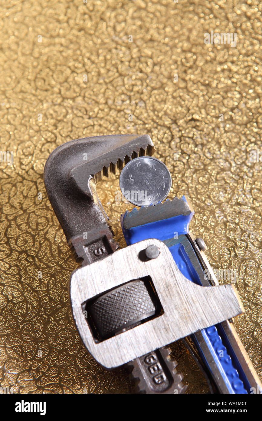 Indian one rupee coin in a wrench Stock Photo - Alamy