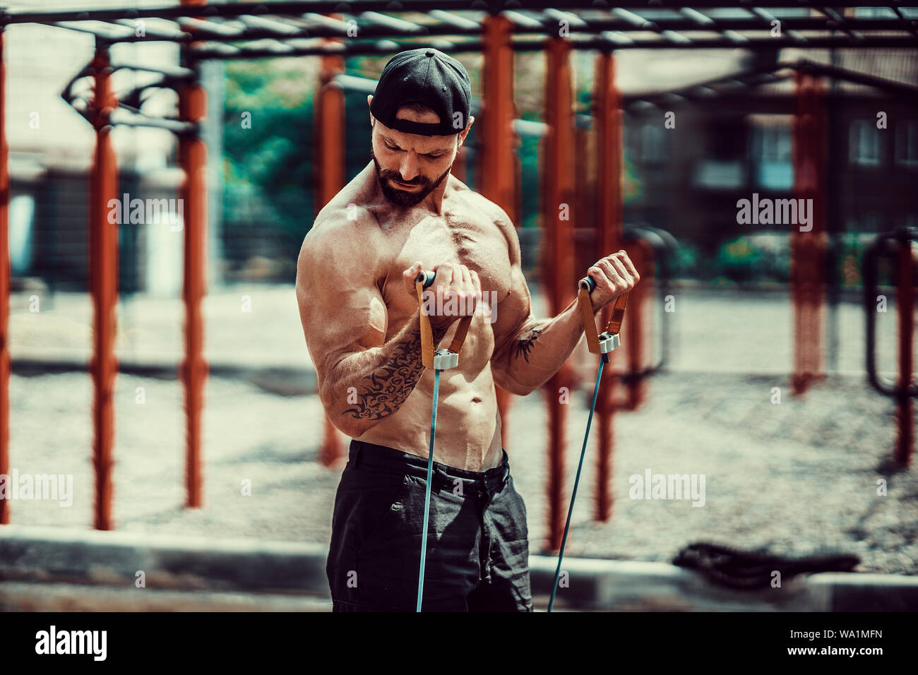 Fitness man exercising with stretching band. Muscular sports man ...