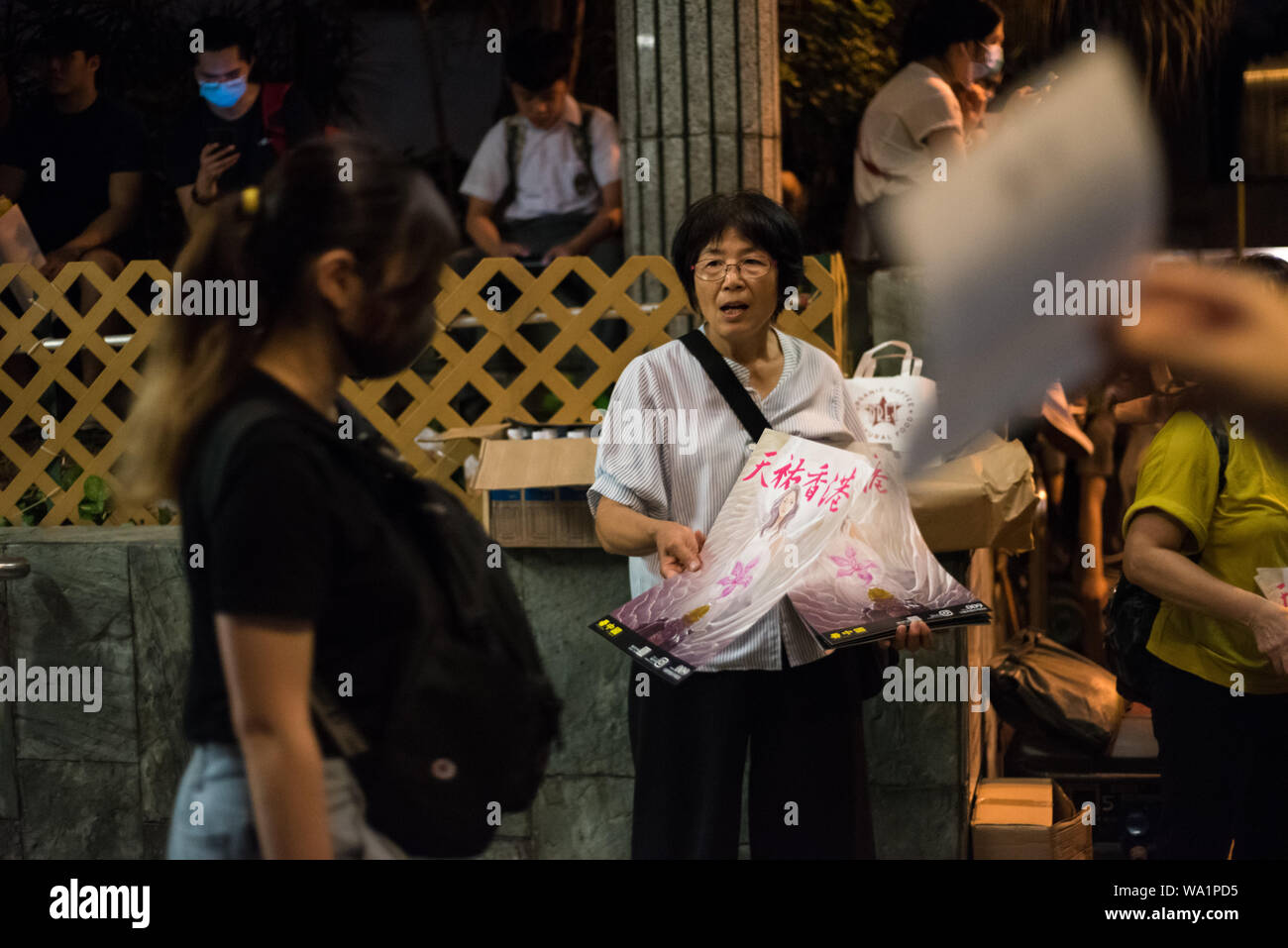 Protester hands out various flyers and placards during the rally ...