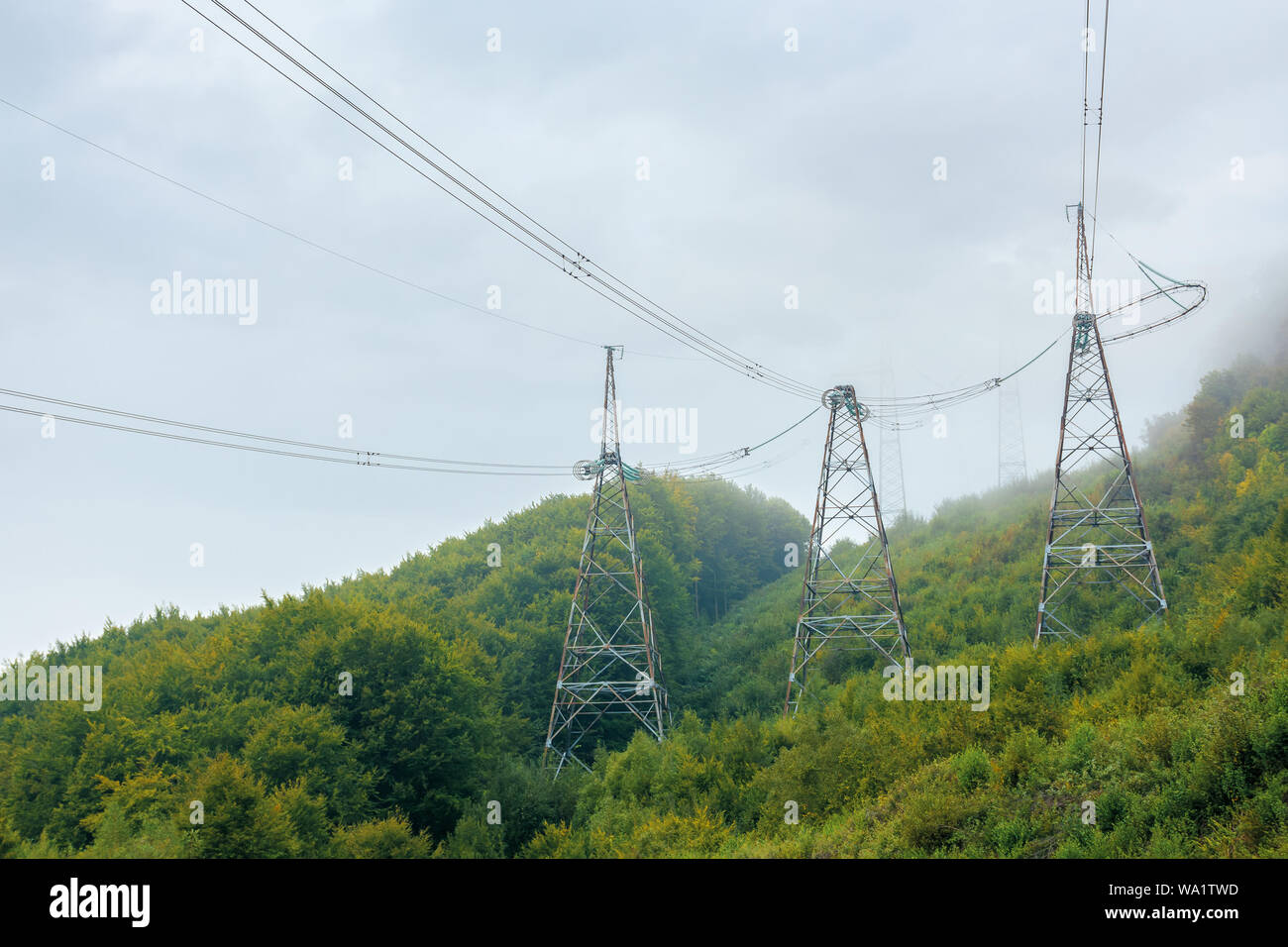 high voltage power lines tower in mountains. energy delivery background ...