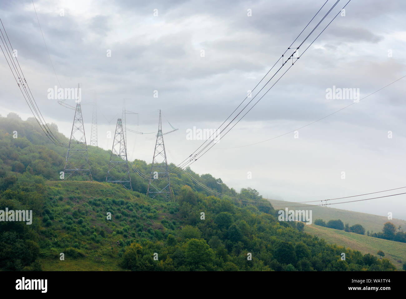 high voltage power lines tower in mountains. energy delivery background ...