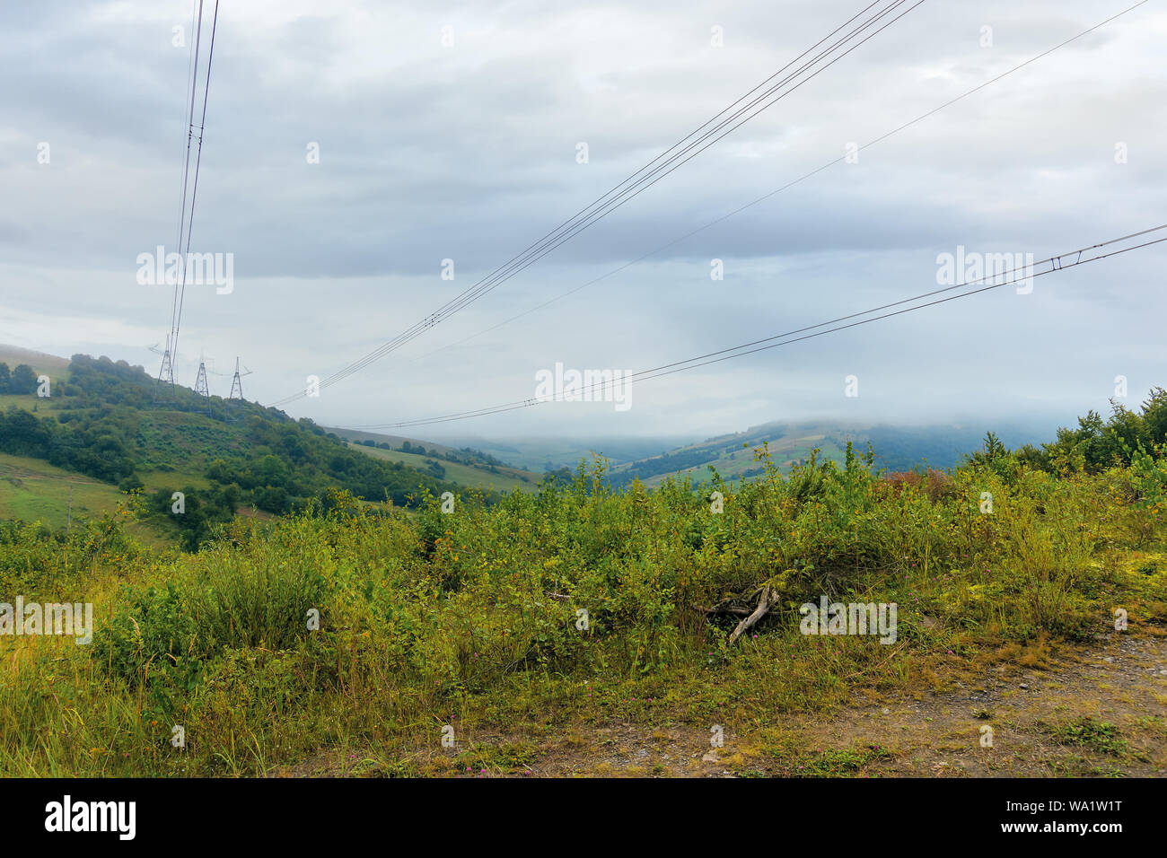 high voltage power lines tower in mountains. energy delivery background ...
