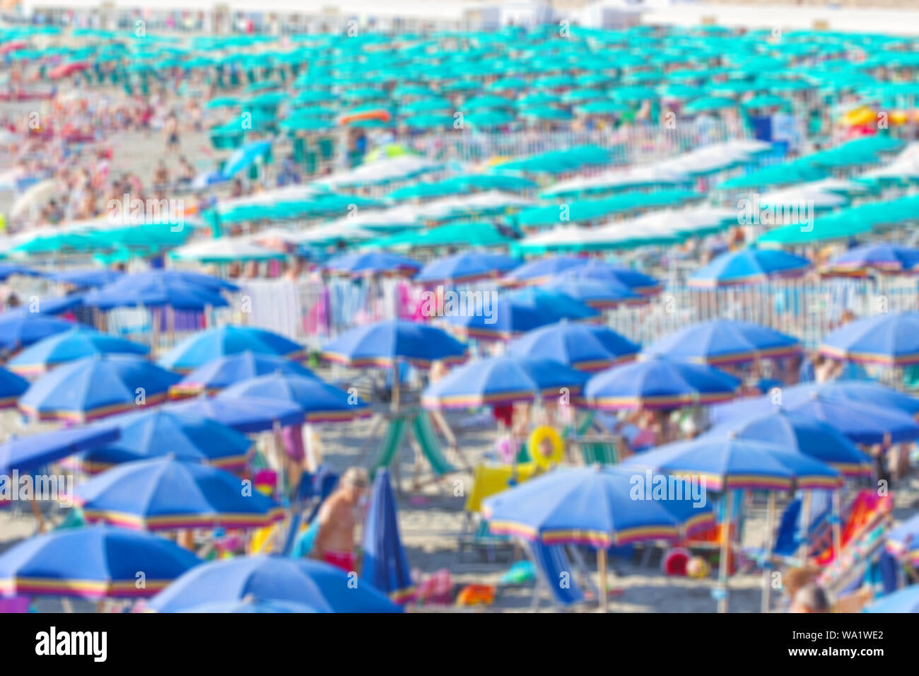 Beach scene on a busy summer day with blurred out people, Beach full of ...