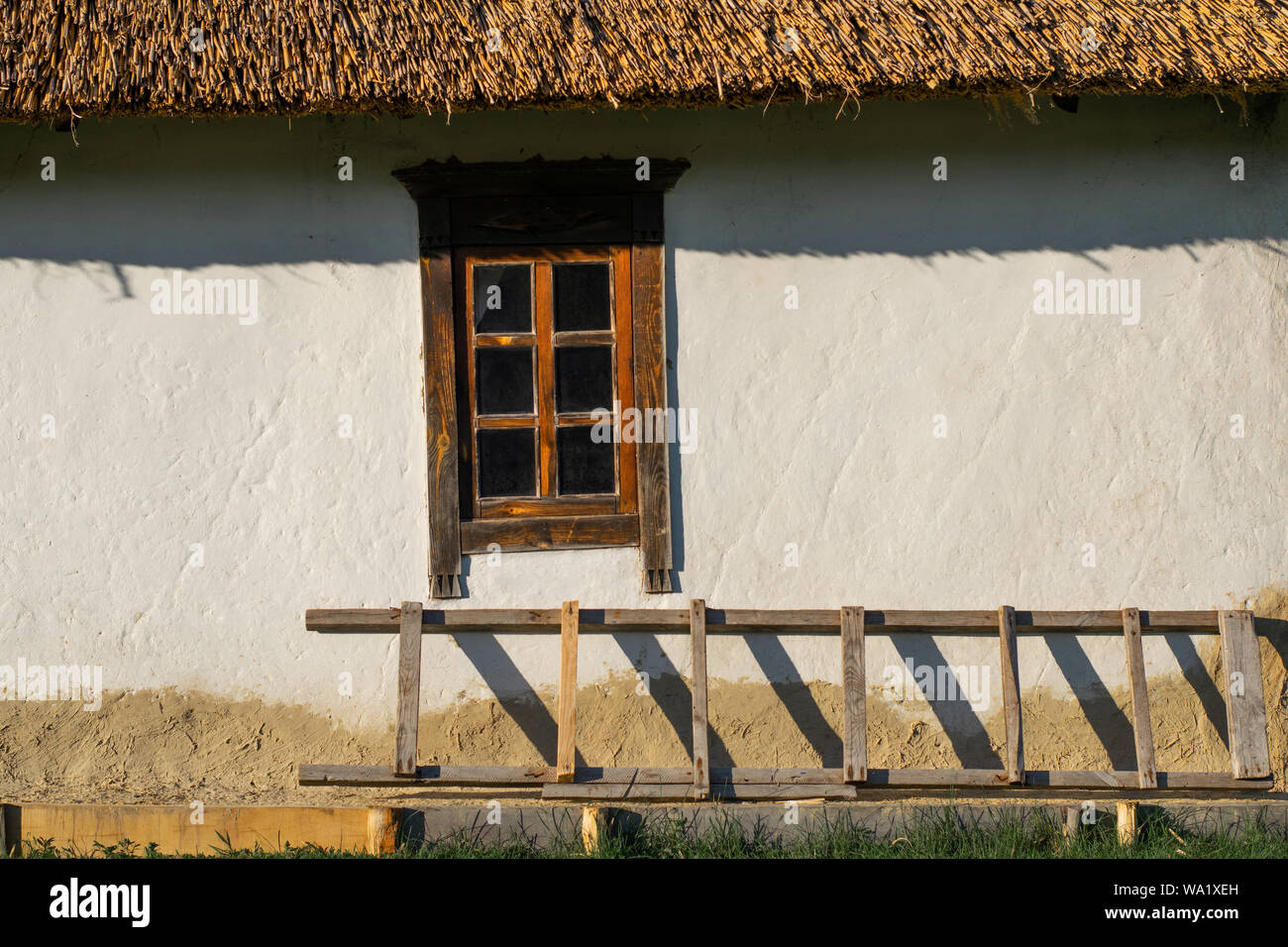 Traditional Ukrainian house. Window in a wooden frame. Roof made of ...