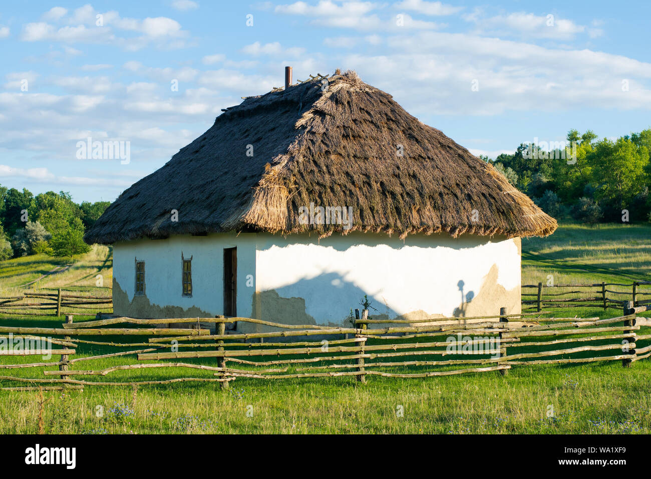 Traditional ukrainian cossack house with thatched roof. The walls of ...