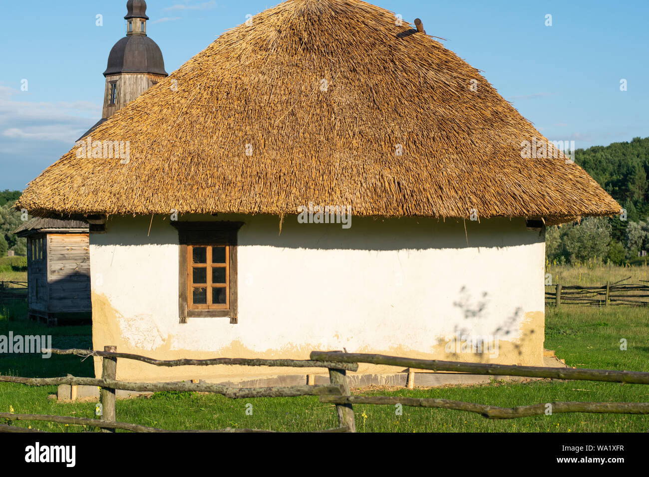 Traditional ukrainian cossack house with thatched roof. The walls of ...