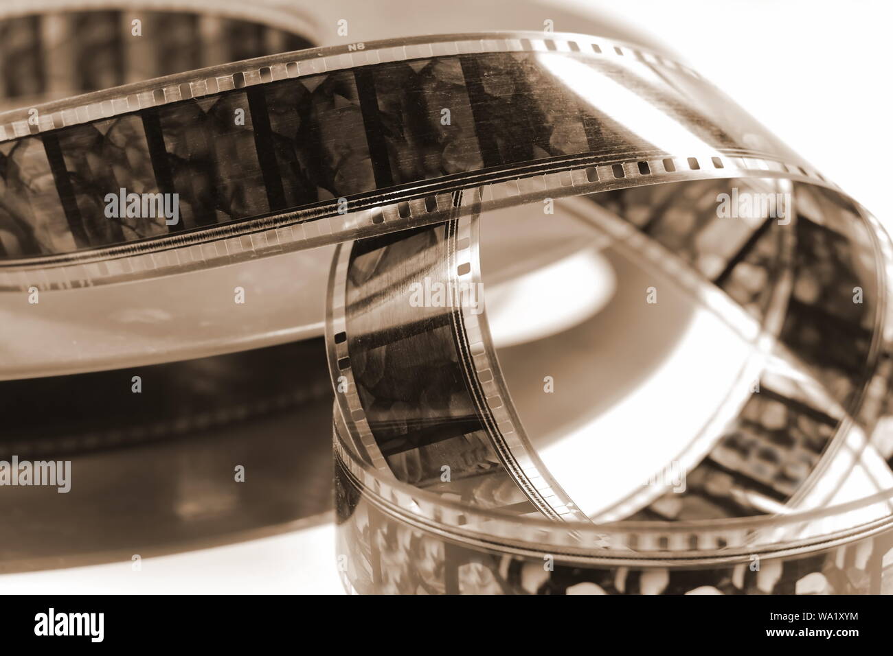 Old cine-film. Film strip on a blur background. Sepia photo Stock Photo - Alamy