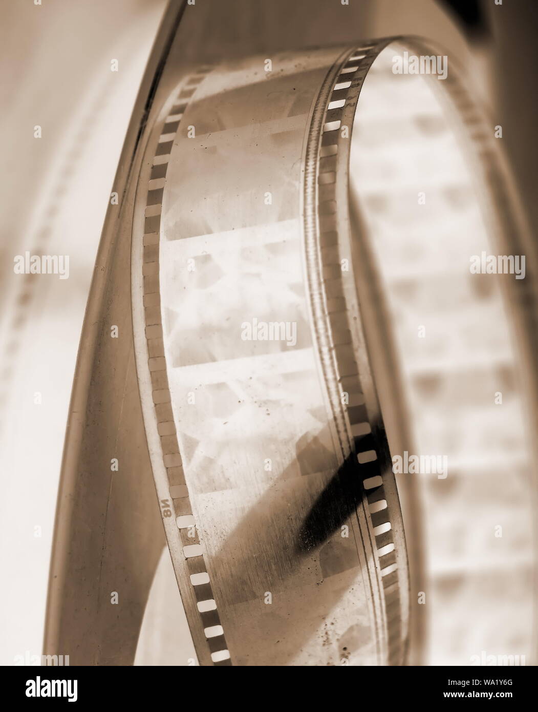 Old cine-film. Film strip on a blur background. Sepia photo Stock Photo - Alamy