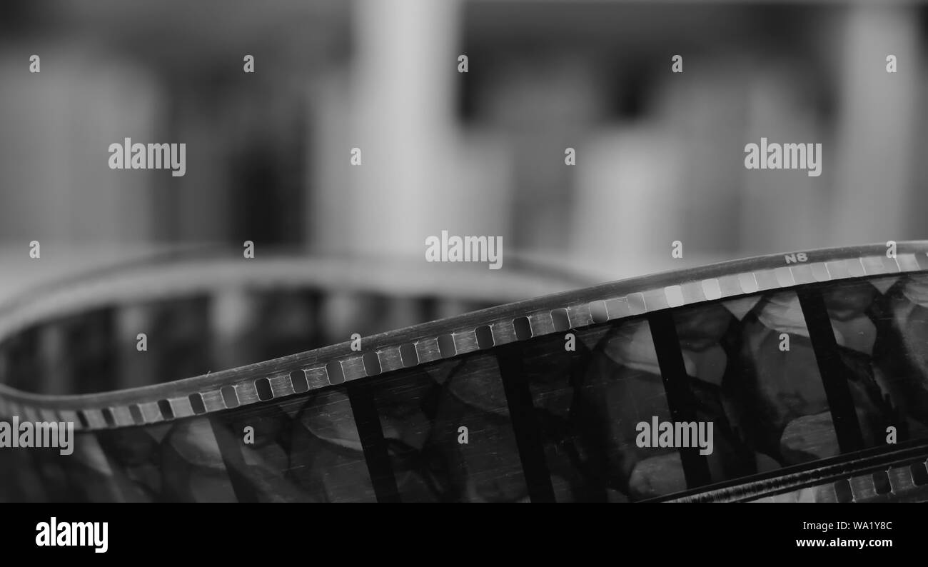 Old cine-film. Film strip on a blur background. Black and white photo ...