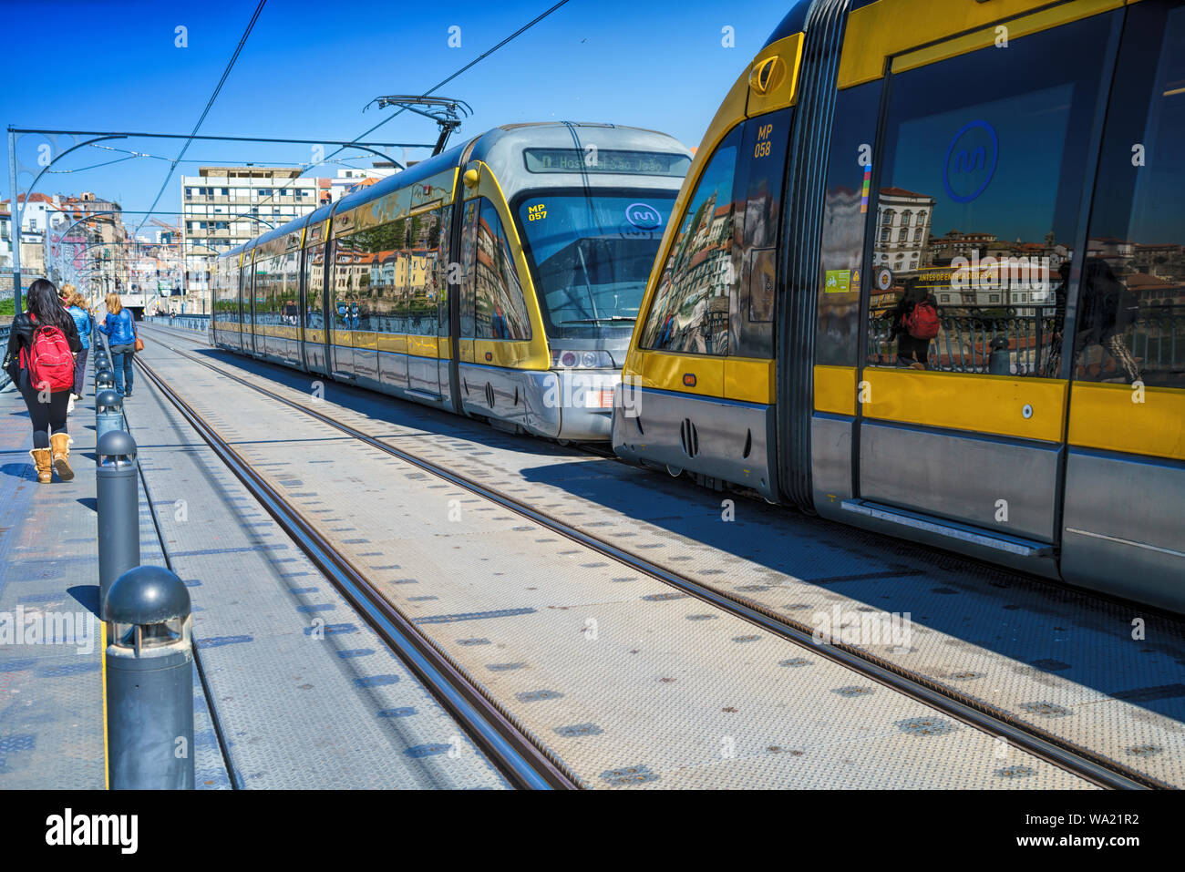 Modern light rail tram over the Dom Luis bridge in Porto city, Portugal ...