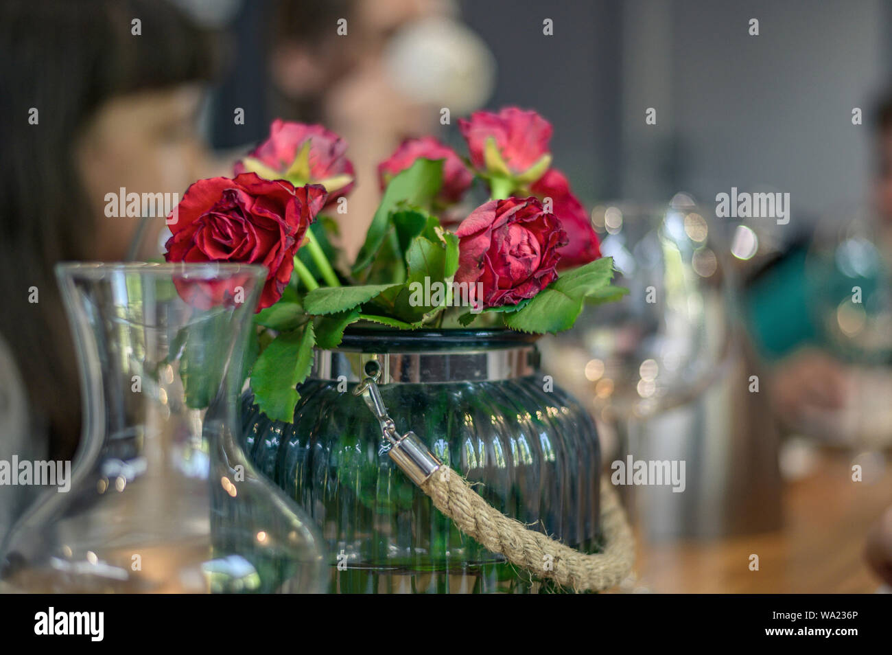Bouquet of red roses on a decorated banquet table in a luxury ...