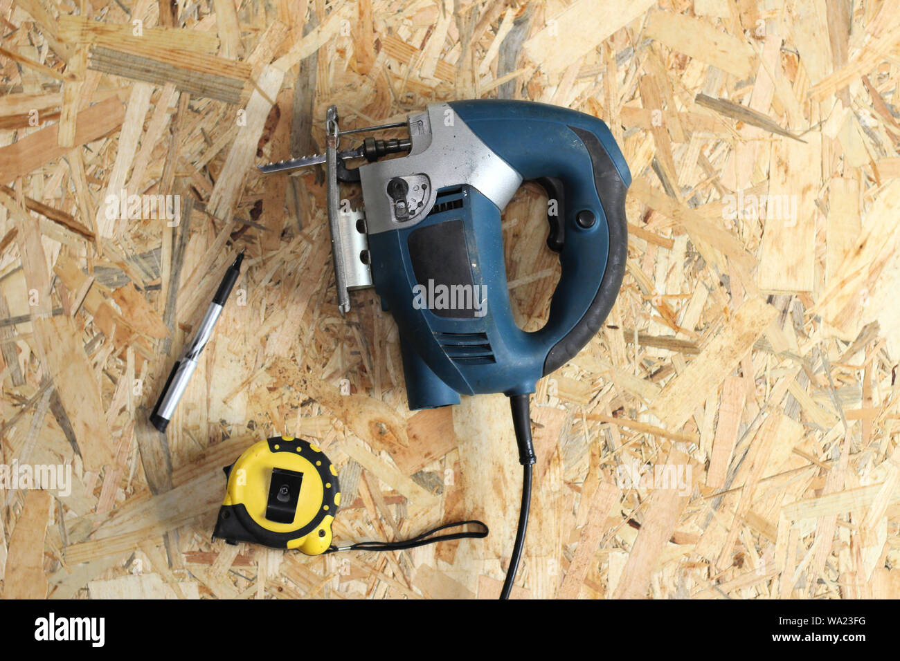 jigsaw, tape measure and pencil on osb plywood Stock Photo - Alamy