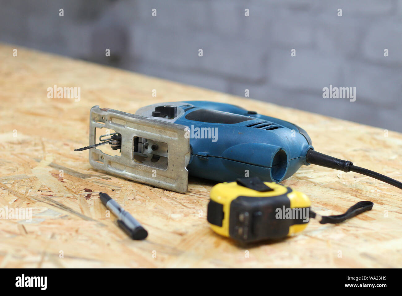 jigsaw, tape measure and pencil on osb plywood Stock Photo - Alamy