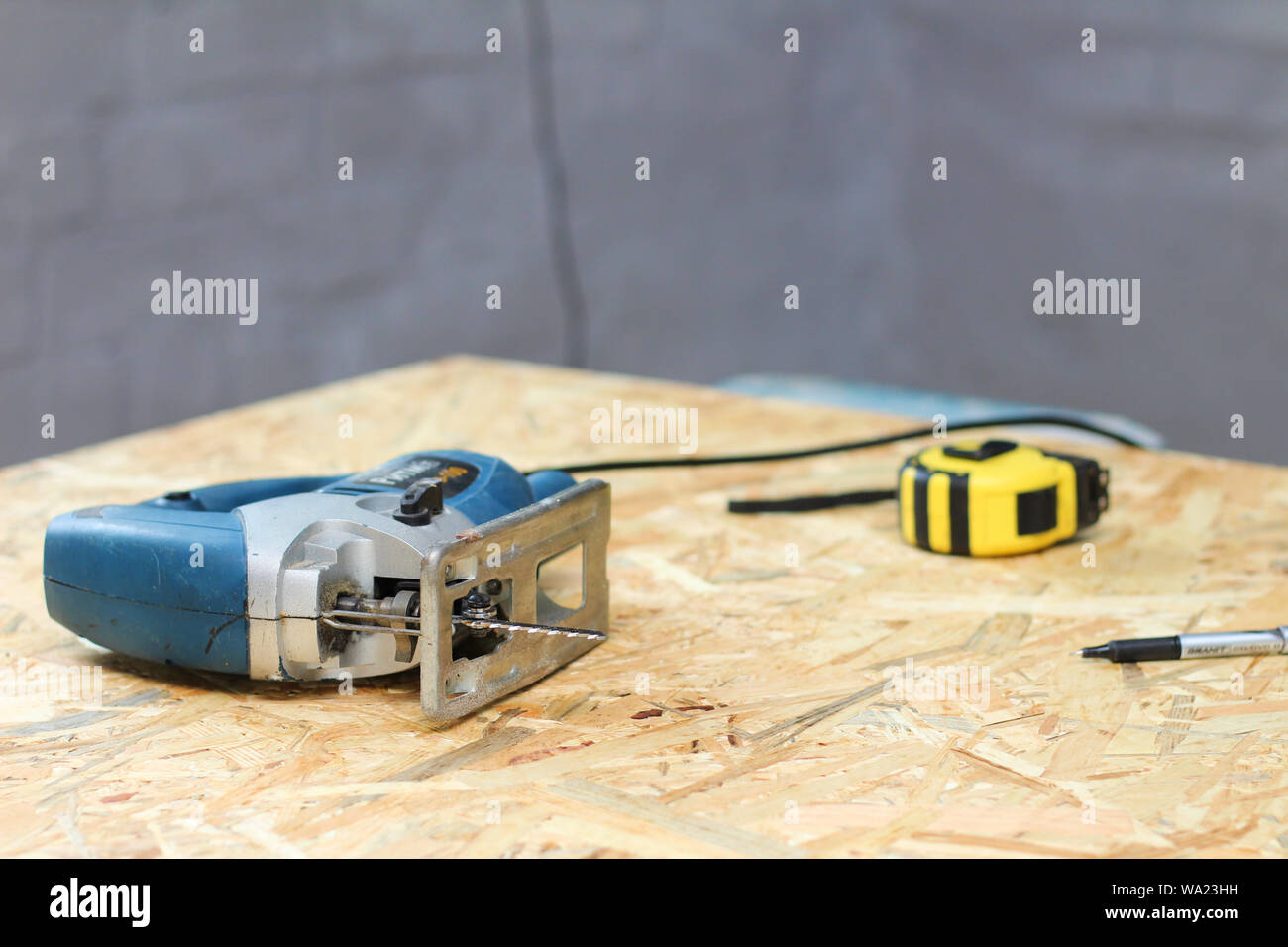 jigsaw, tape measure and pencil on osb plywood Stock Photo - Alamy