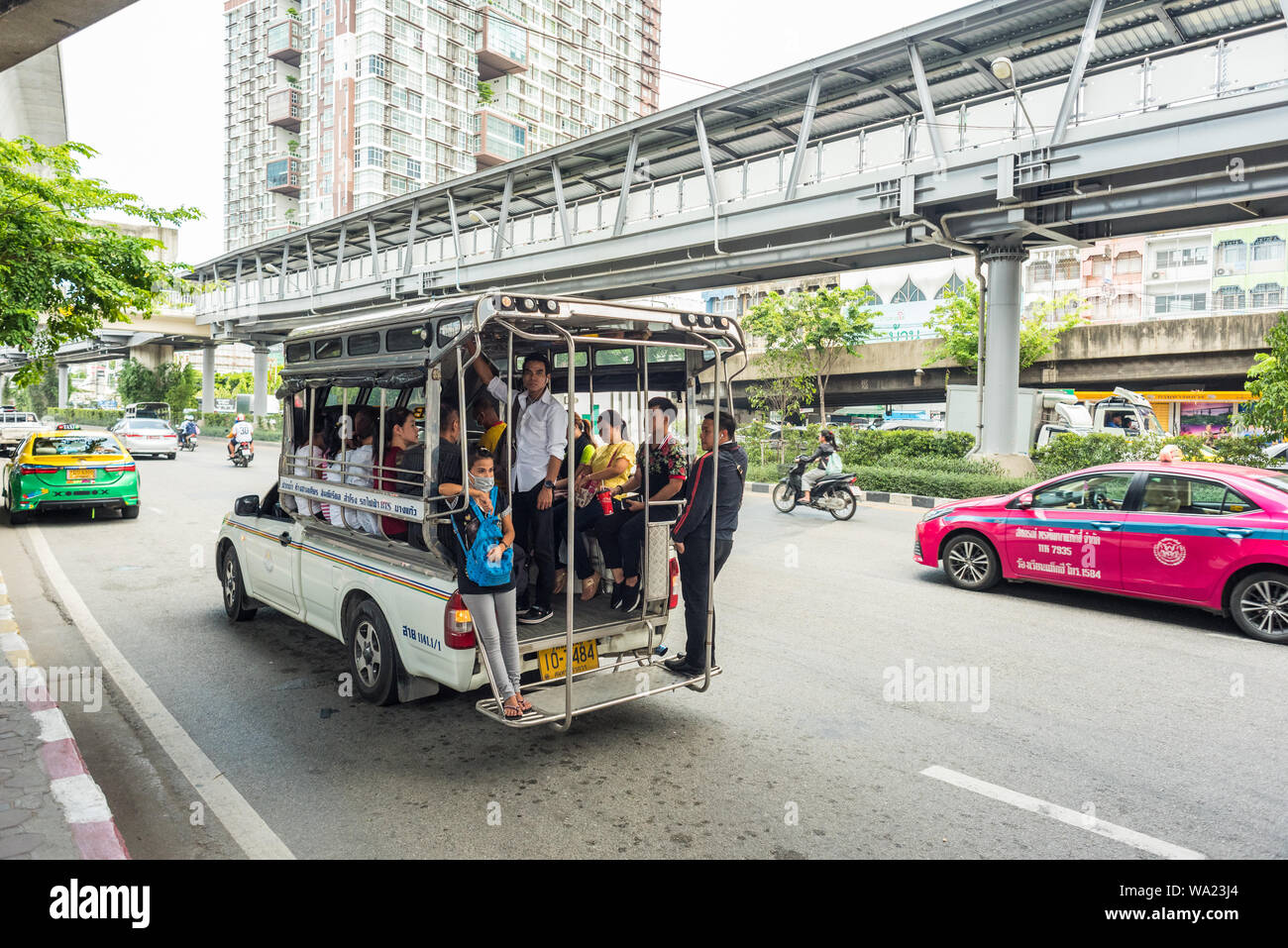 Bangkok: a songthaew with passengers in it, on the street in Bangna ...