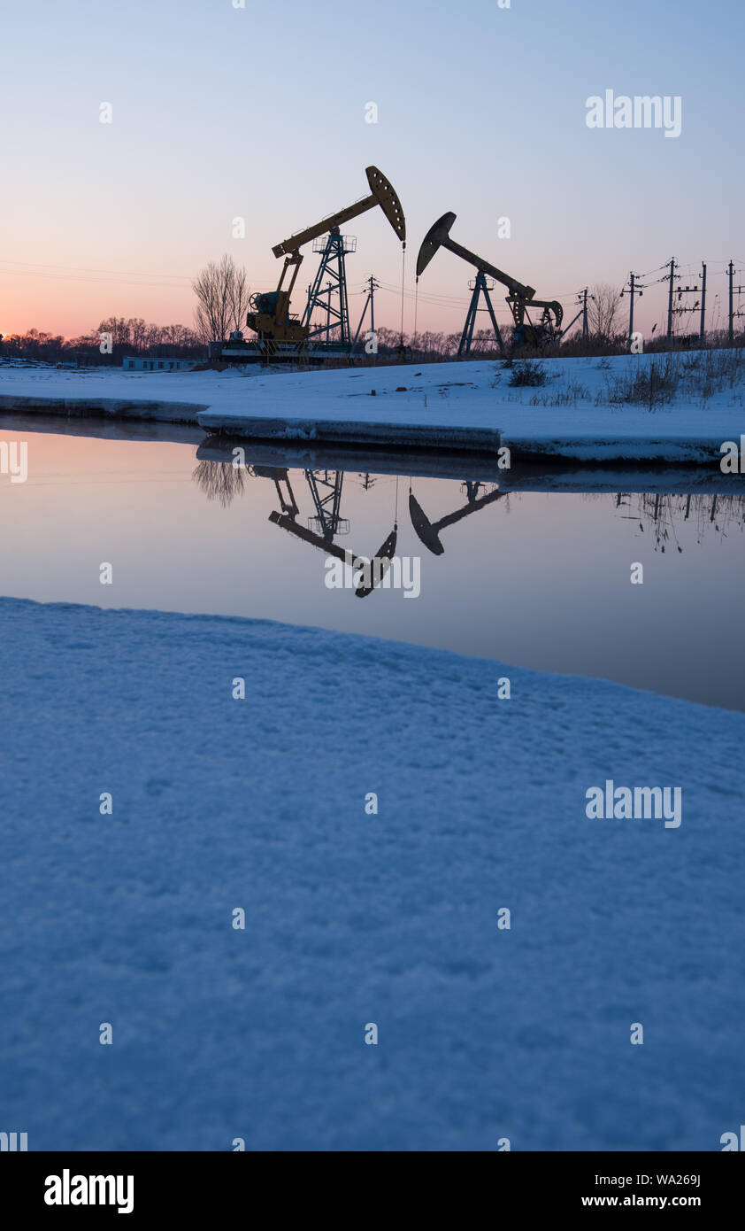 Winter beam pumping unit Stock Photo - Alamy