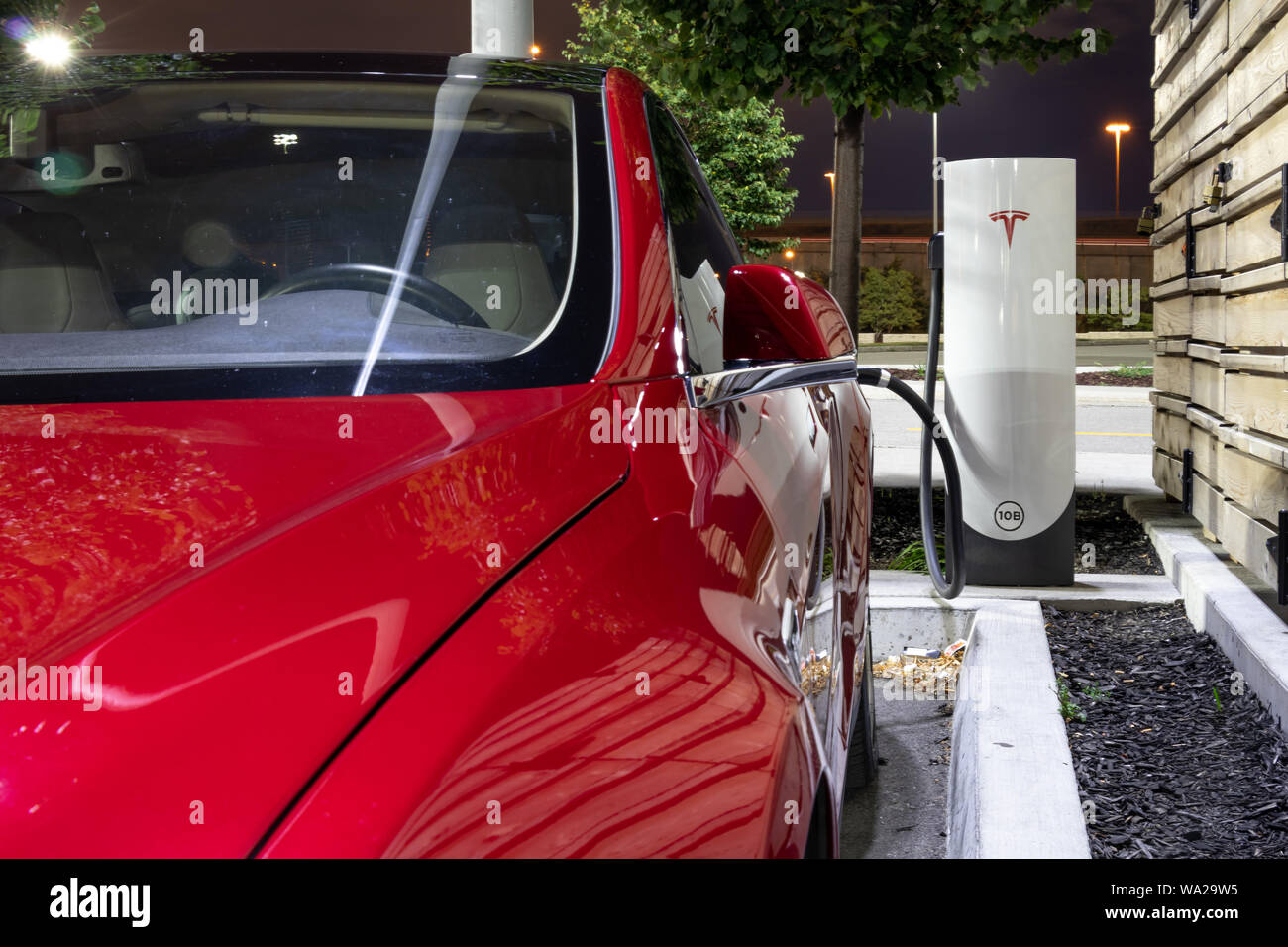 Tesla Model S plugged-in at Tesla Supercharger Stock Photo - Alamy