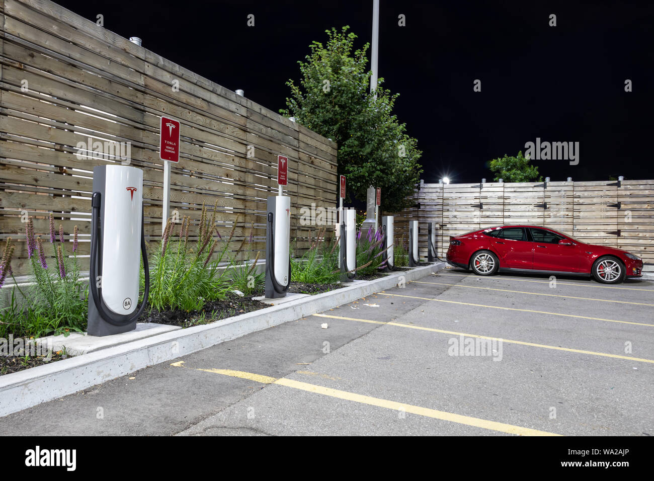 Tesla Model S supercharging at night Stock Photo - Alamy