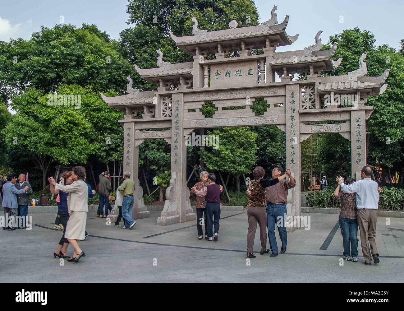 Shanghai, China. 30th Oct, 2006. Couples dance near a traditional arch ...