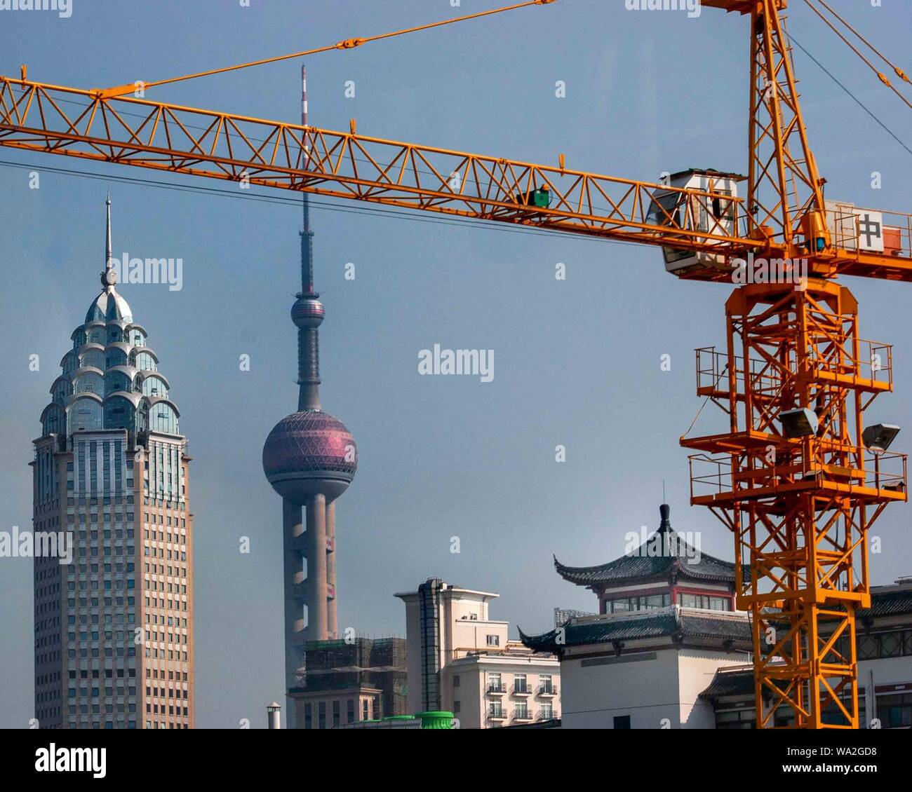 Shanghai, China. 30th Oct, 2006. A construction crane frames a new ...