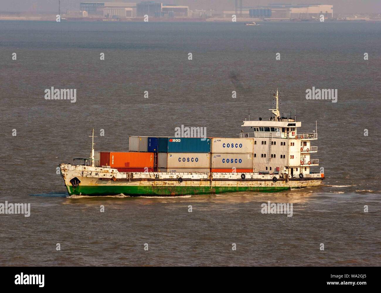 Shanghai, China. 30th Oct, 2006. A small container ship underway in the ...