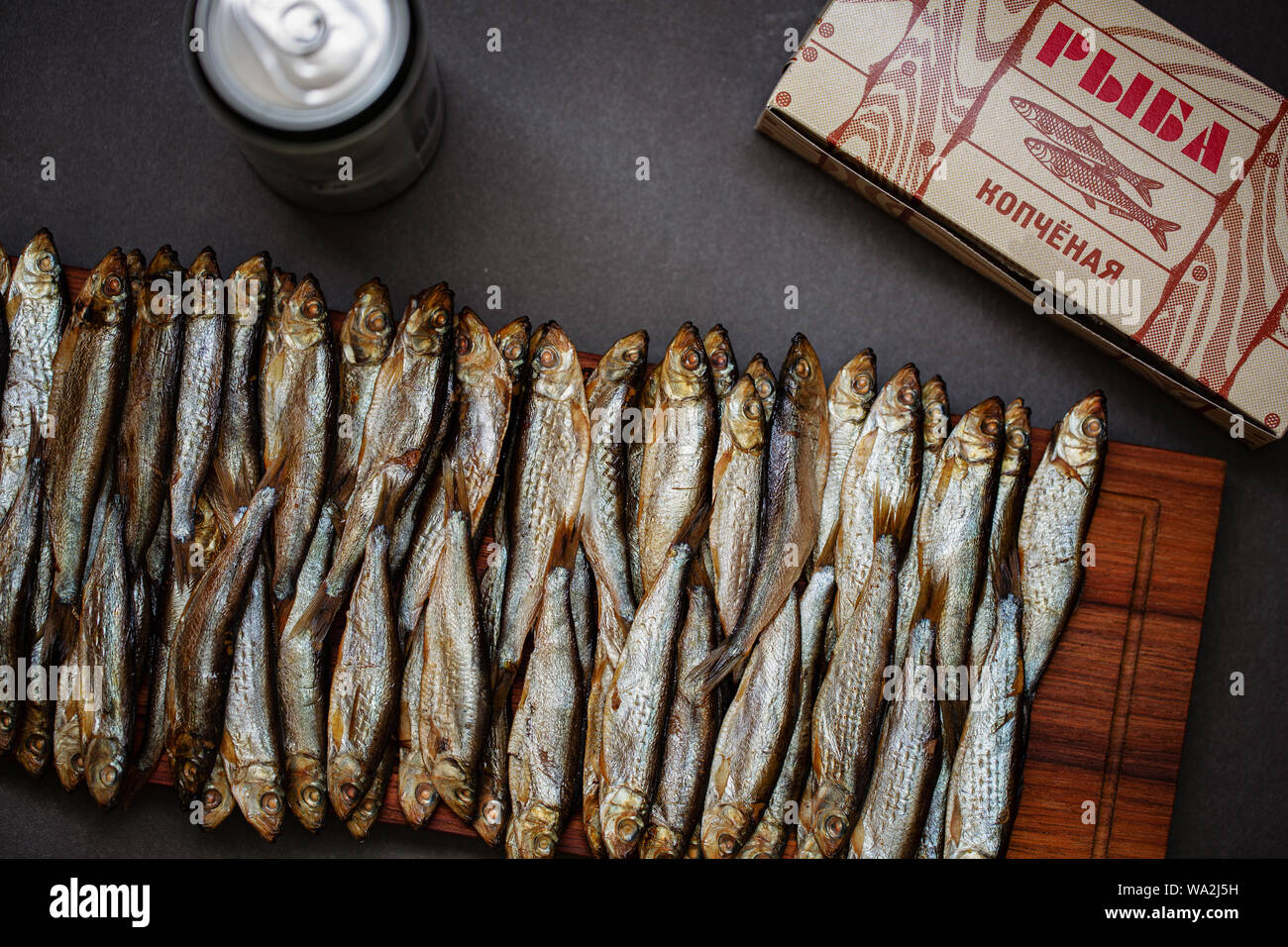 Hot smoked sprat on a cutting board Stock Photo - Alamy