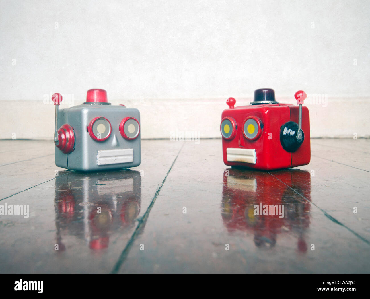 two metal robot heads chatting on a wooden floor with copy space Stock ...