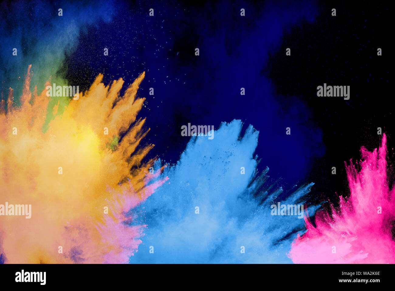 Colorful powder explosion cloud on black background. Freeze motion of ...