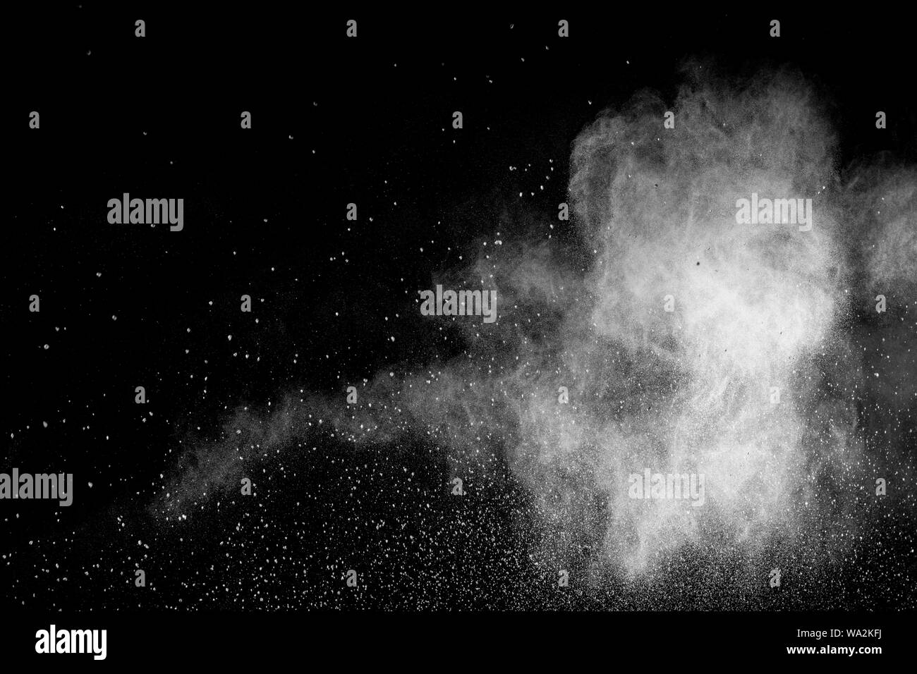 Bizarre forms of white powder explosion cloud against black background ...