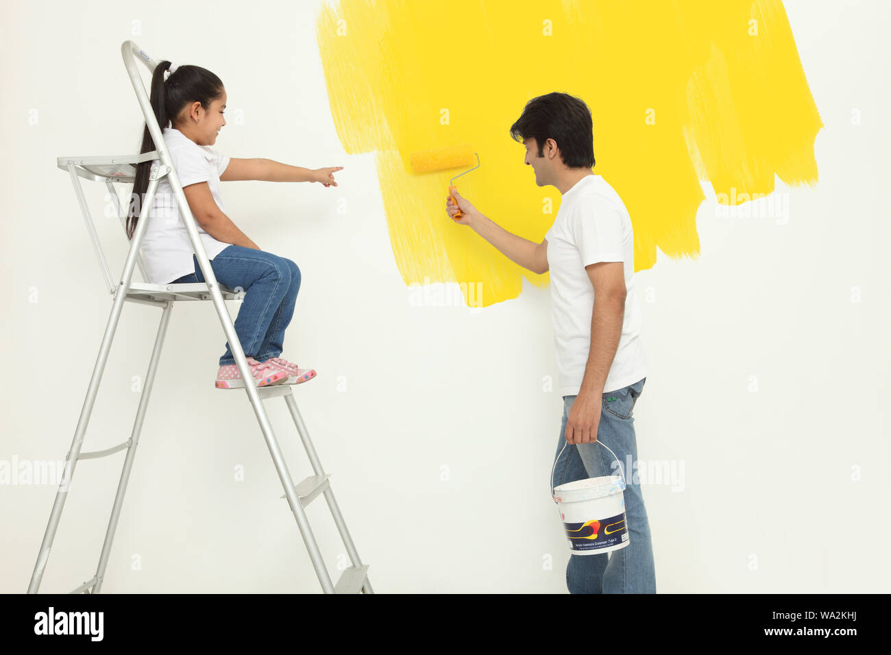 Father with his daughter painting on wall Stock Photo - Alamy