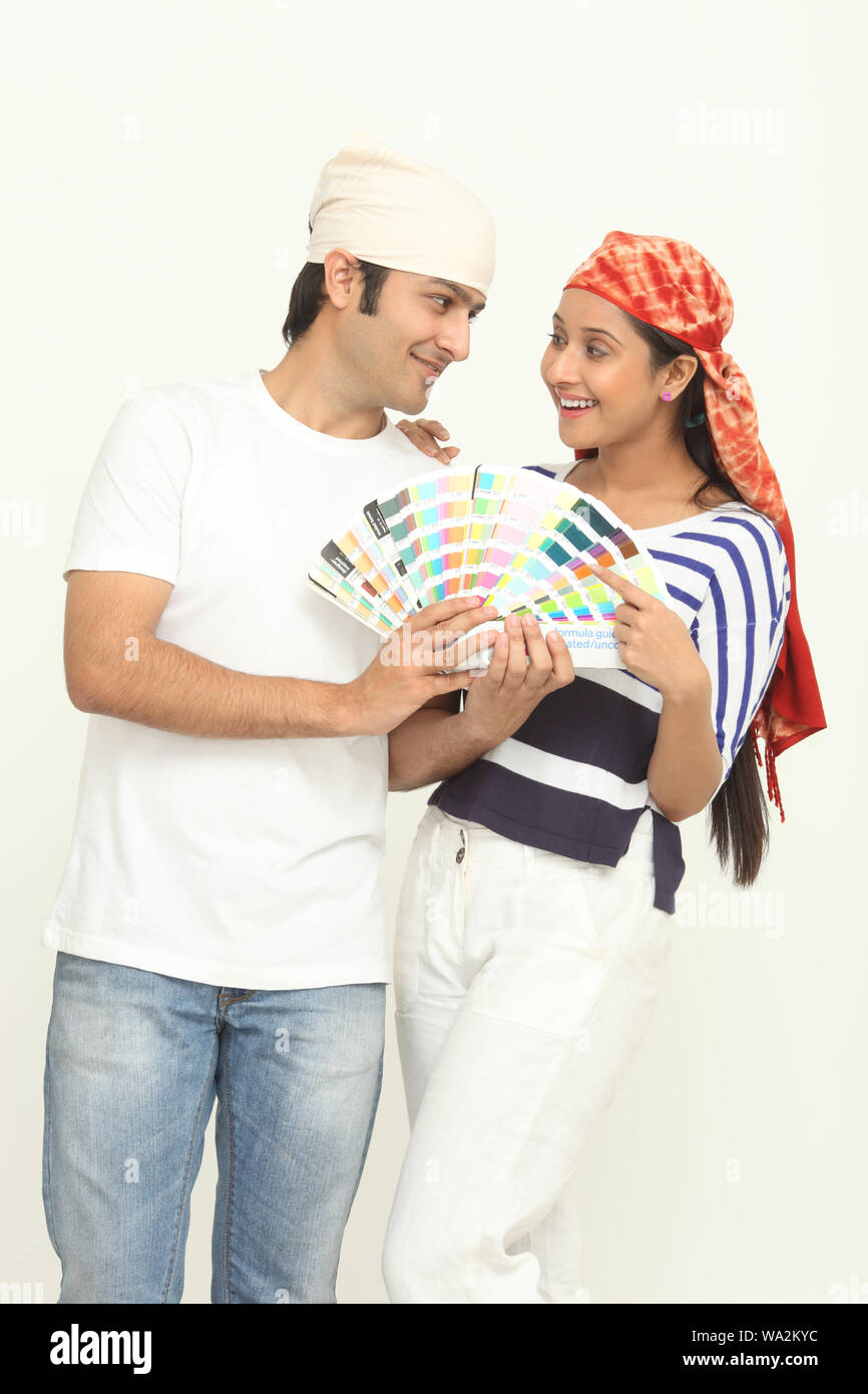 Young couple choosing colours from colour sample Stock Photo - Alamy