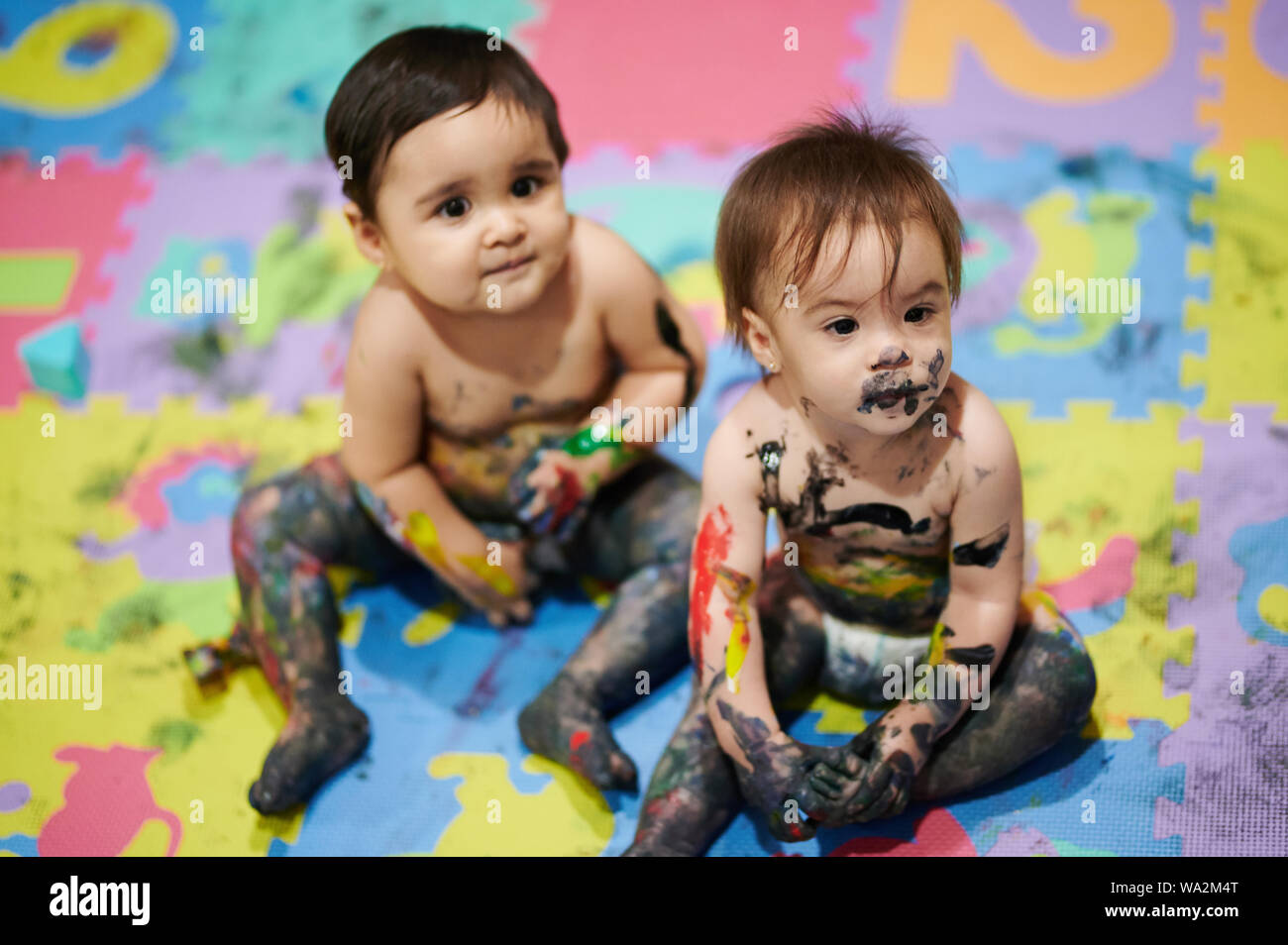 Babies playing with paint. Messy kids having fun with colorful paint ...