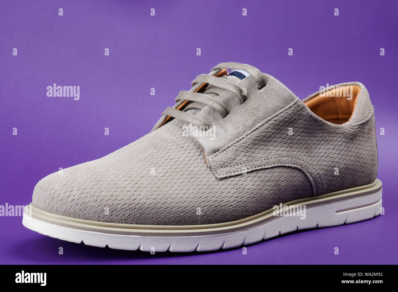 One gray modern man shoe side view isolated on purple background Stock ...