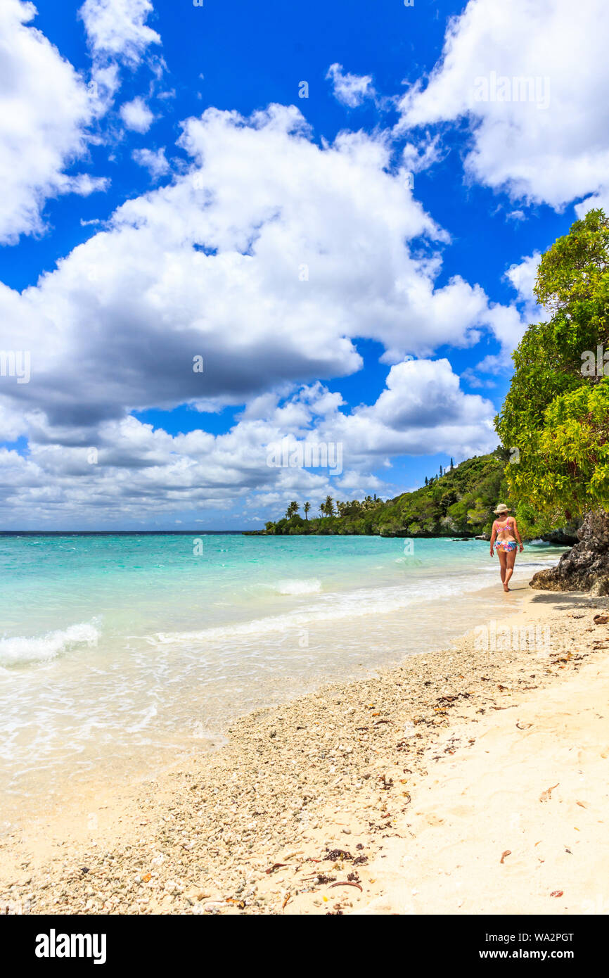 Senior woman walking on white sand Easo beach, Lifou, New Caledonia ...