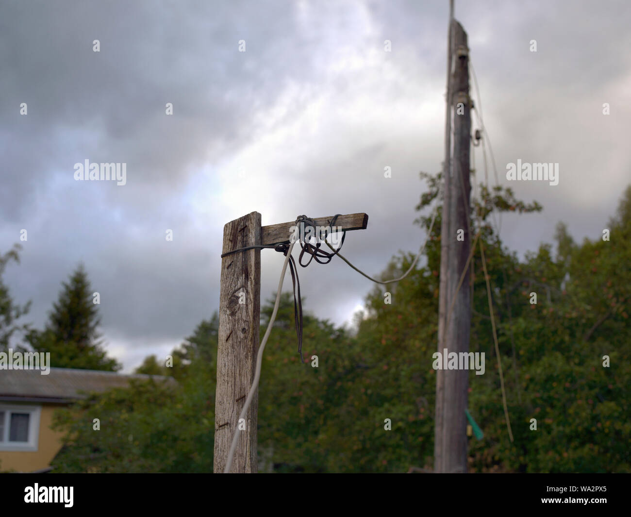 Landscape with old wooden electric pole and sagged wires Stock Photo ...