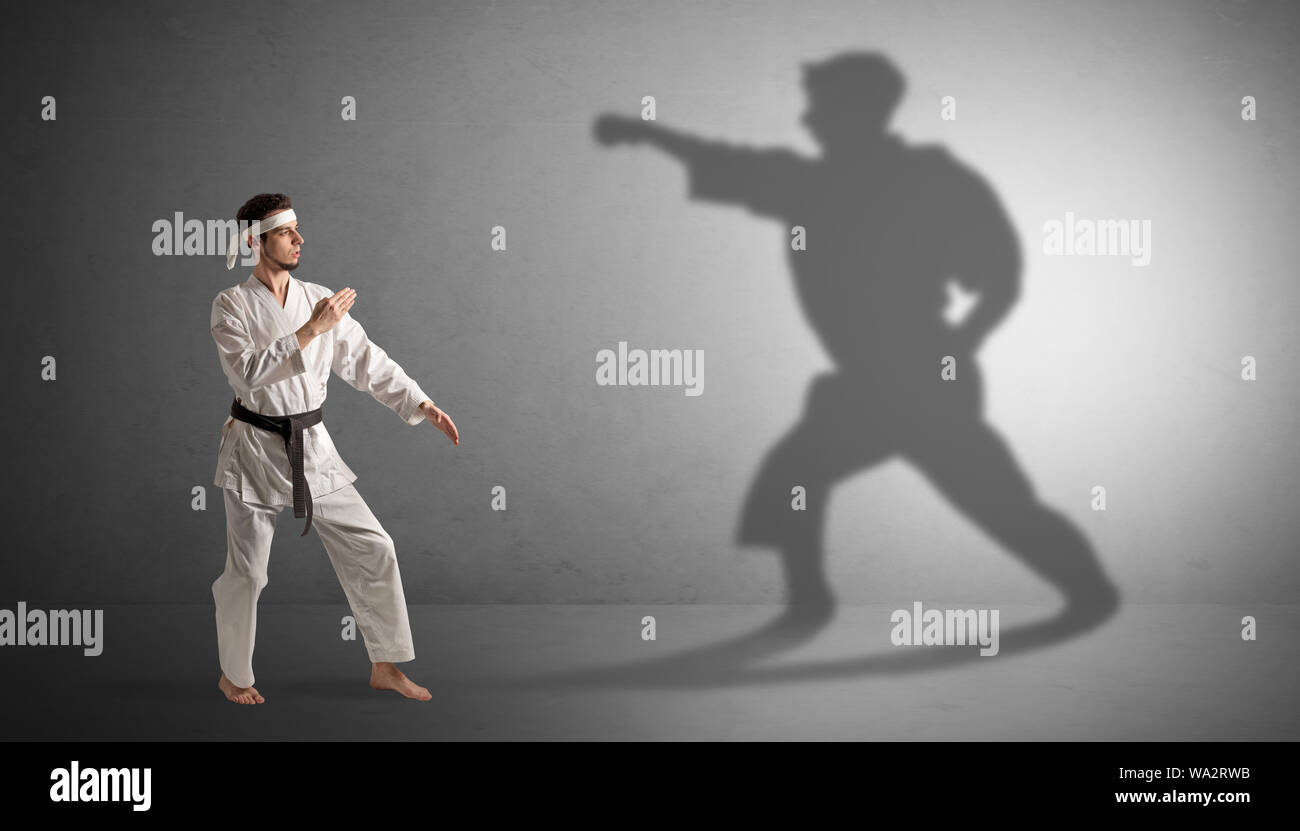 Young karate man confronting with his own shadow Stock Photo - Alamy