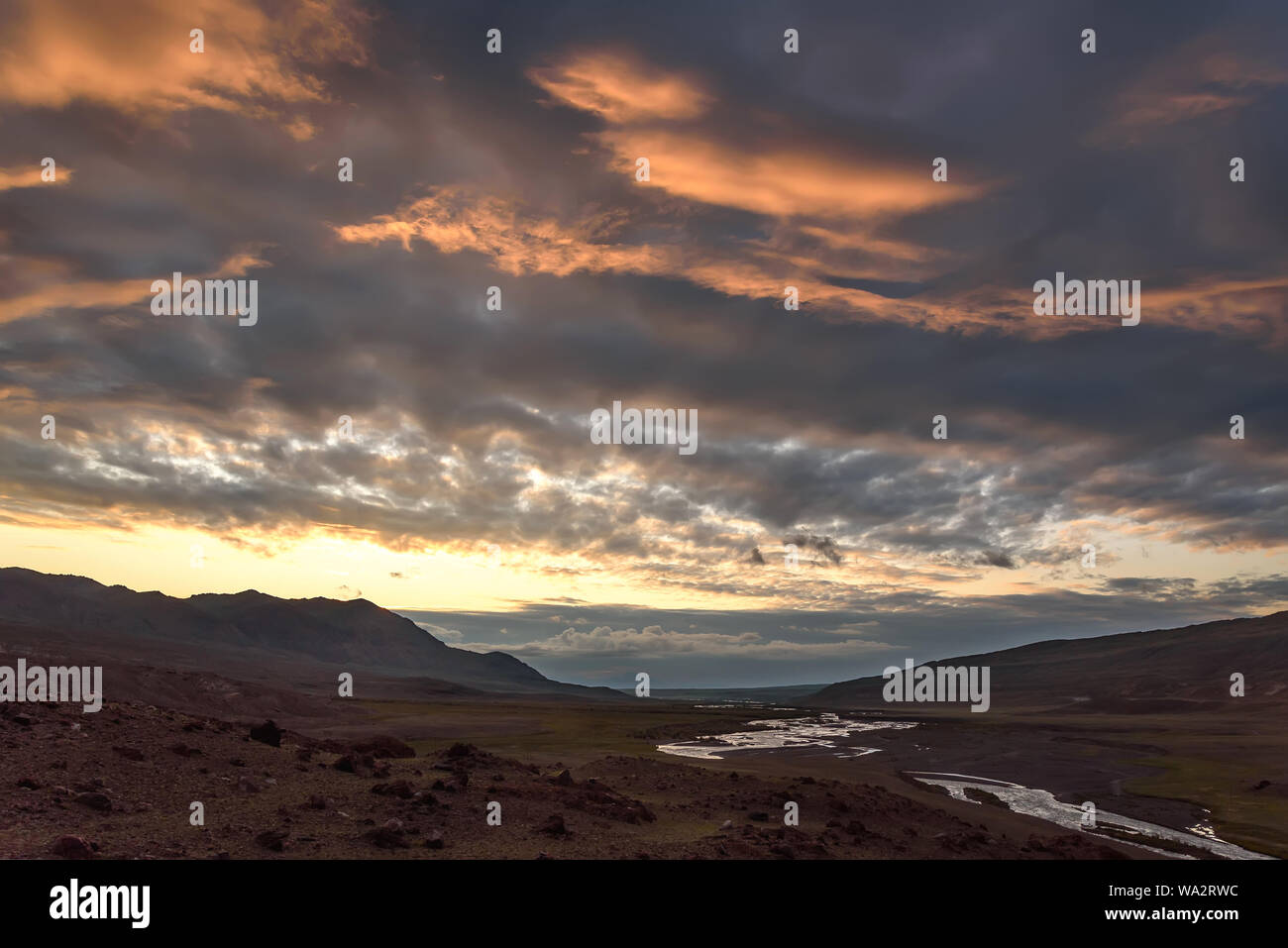 Amazing golden sunrise with mountains and a valley with a winding river ...