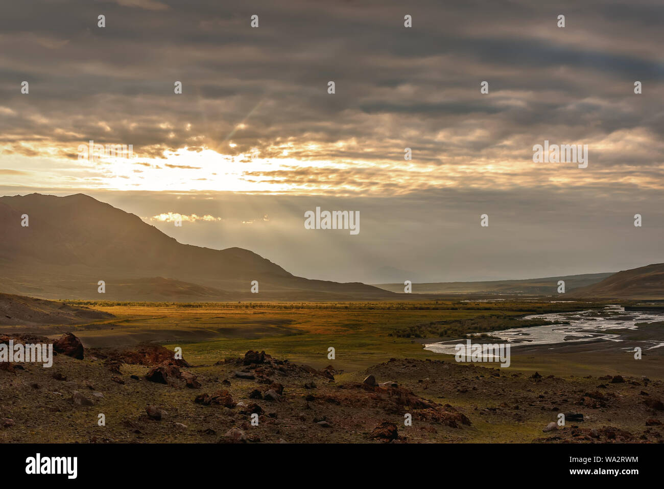 Amazing golden sunrise with mountains and a valley with a winding river ...