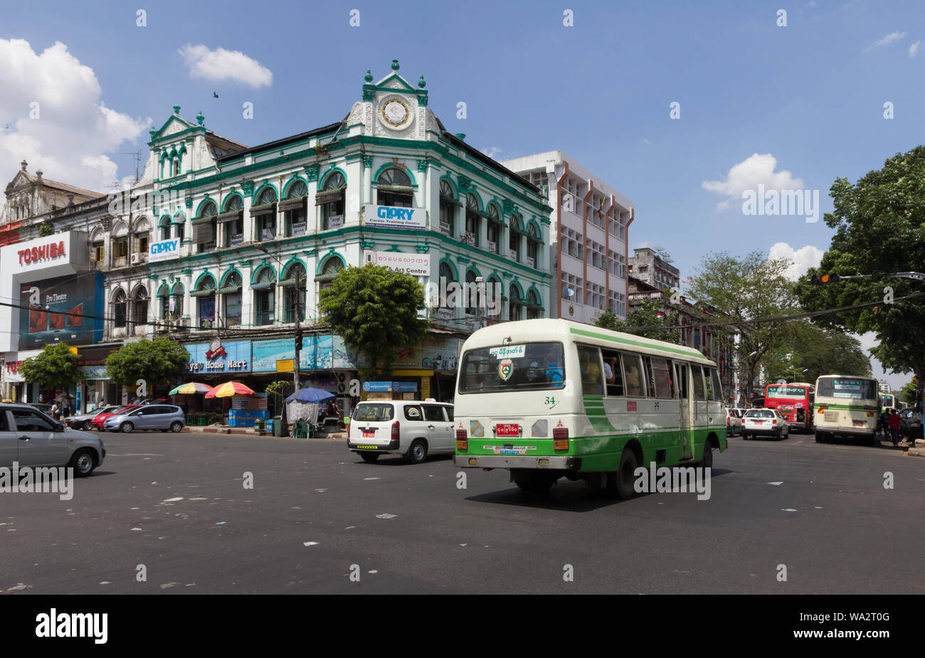 Yangon, Myanmar-May 8th 2014: A bus passes through an intersection in ...