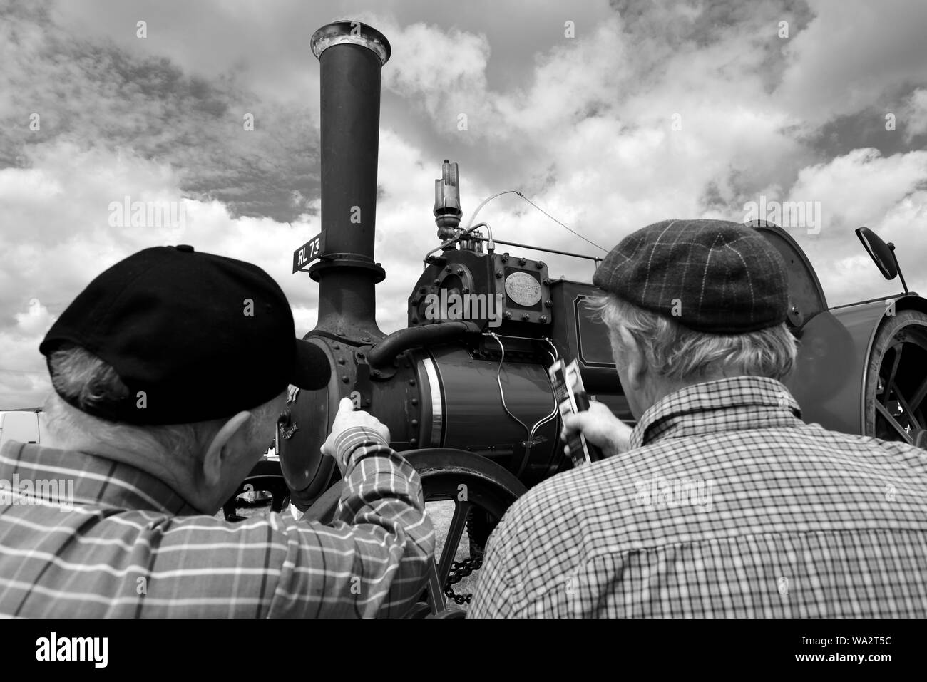 Two old men discussing a steam engine Stock Photo - Alamy