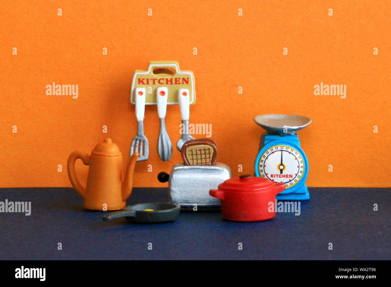 Cookware figures lined up in a colorful kitchen Stock Photo - Alamy