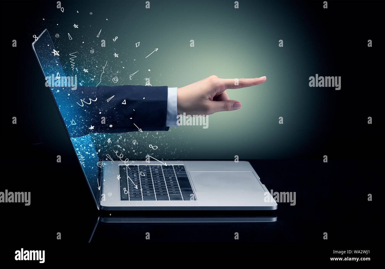 Hand coming out of a laptop with sparkling effects Stock Photo - Alamy
