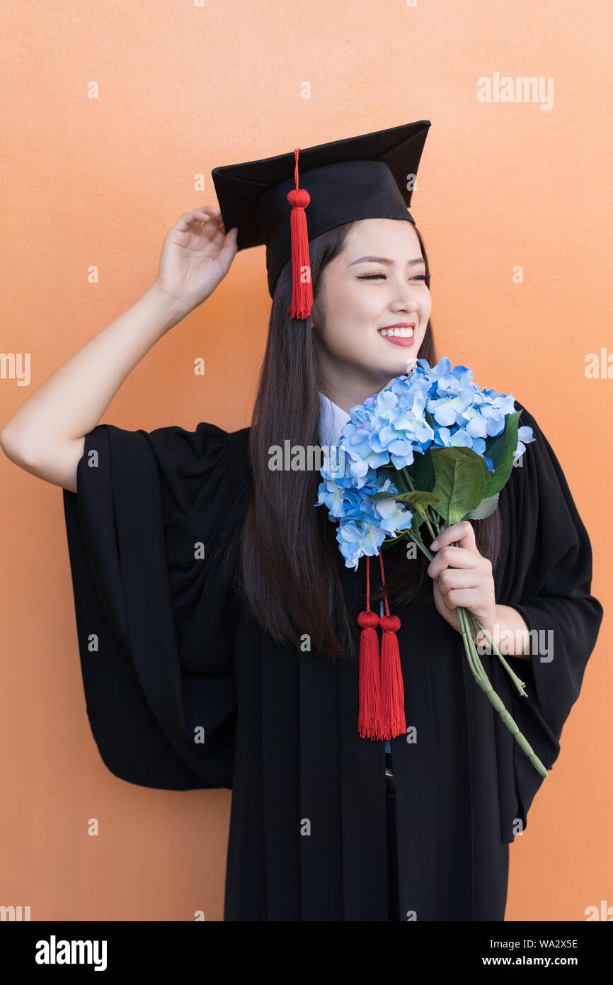 Portrait closeup. Asian beautiful smiley graduate graduated student ...