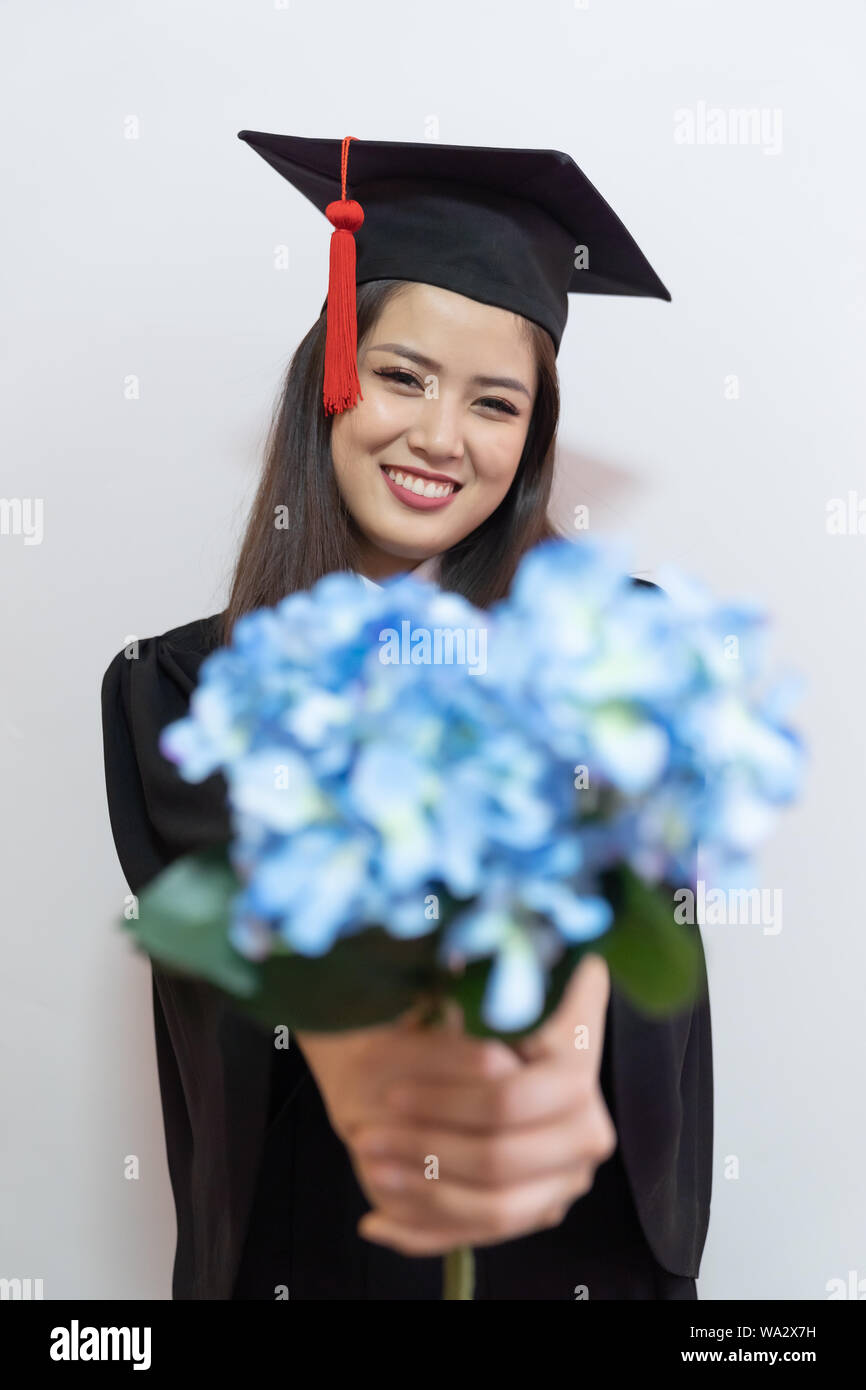 Portrait closeup. Asian beautiful smiley graduate graduated student ...