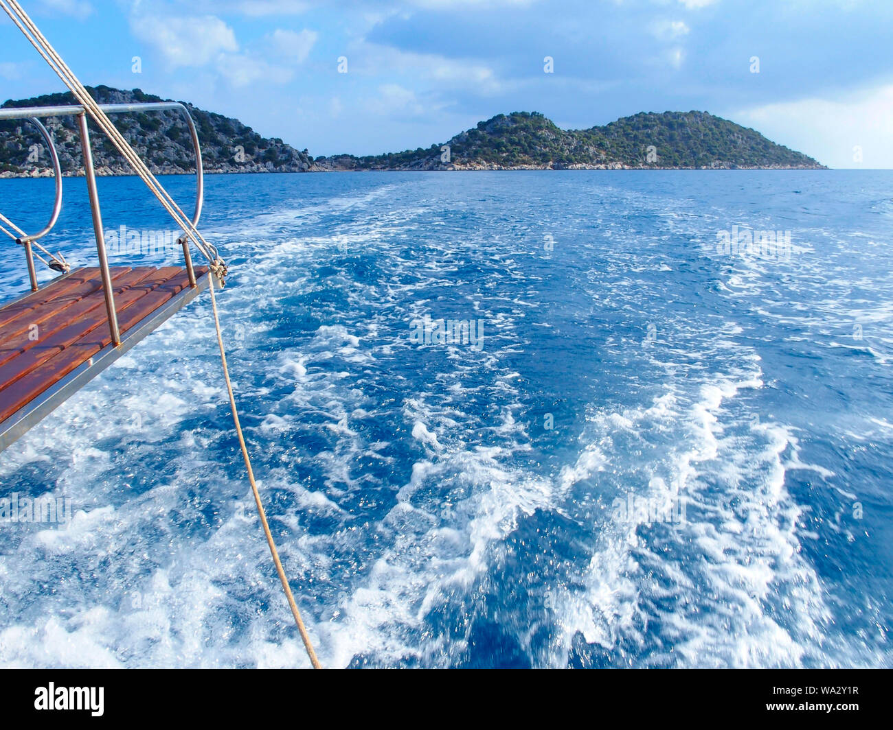 long wooden swim platform with a reeling and ship waves beyond Stock ...