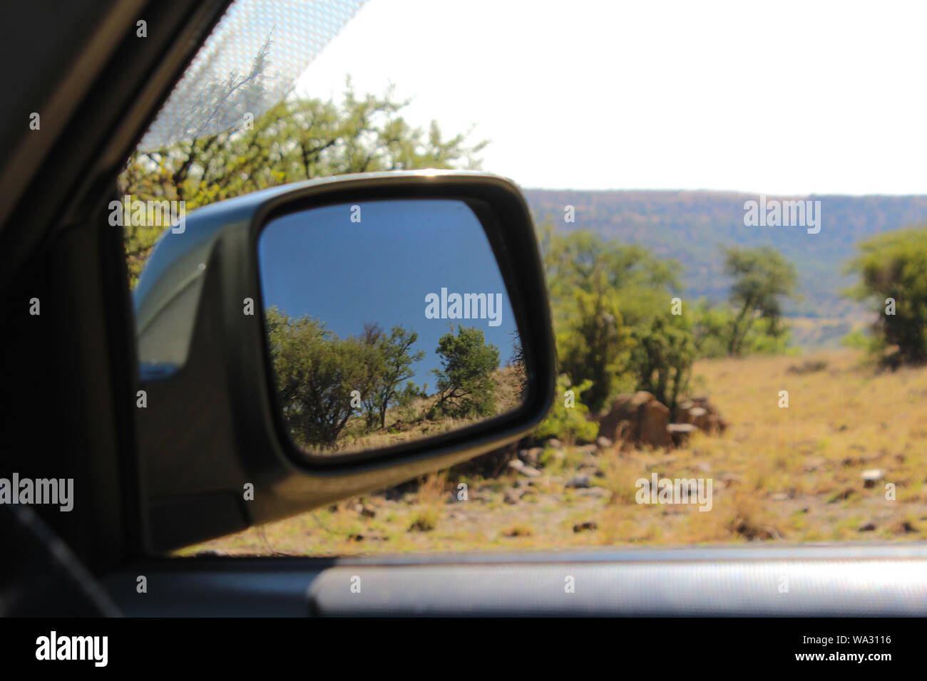 Reflection of a landscape in a car mirror Stock Photo - Alamy