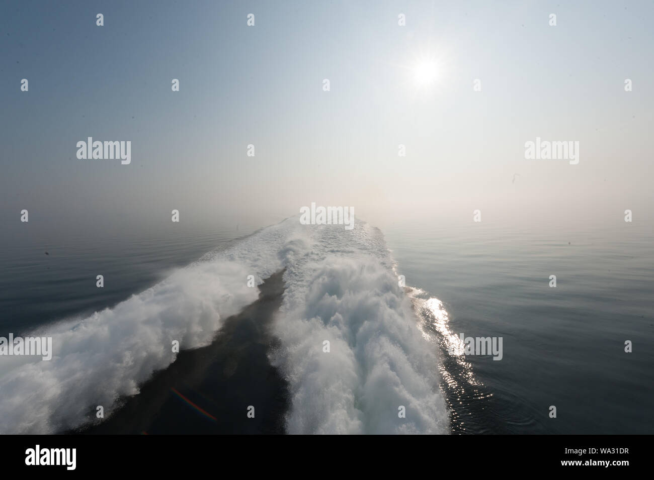 Wake of a fast catamaran passenger ferry on a sunny day with calm seas ...