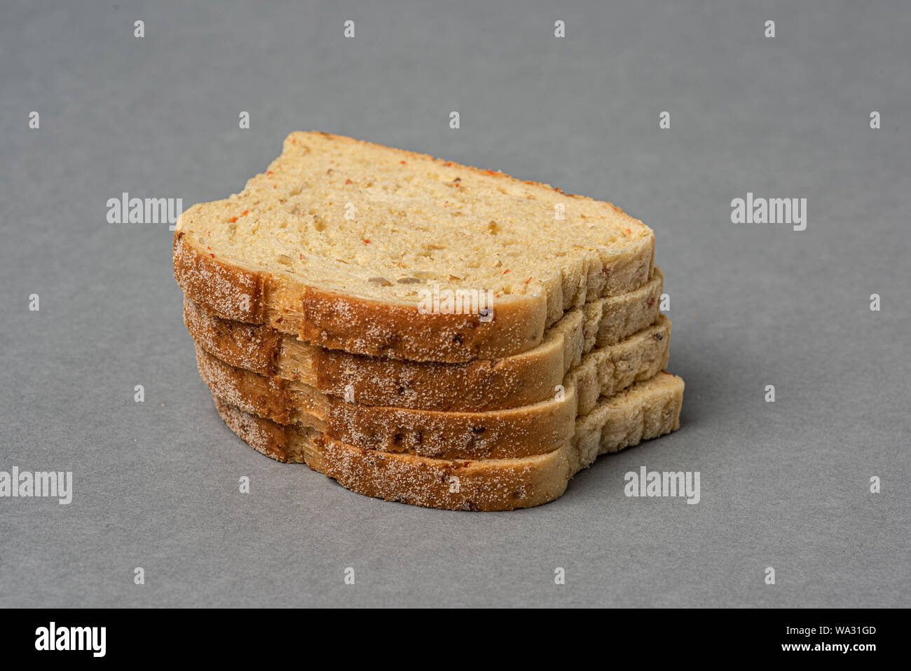Four slices of bread on grey background Stock Photo - Alamy