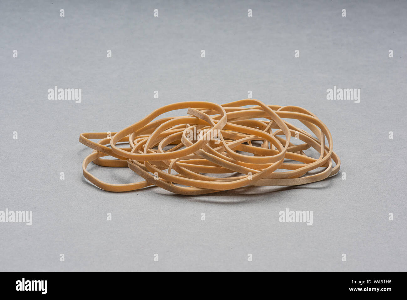 Rubber bands on grey background Stock Photo - Alamy