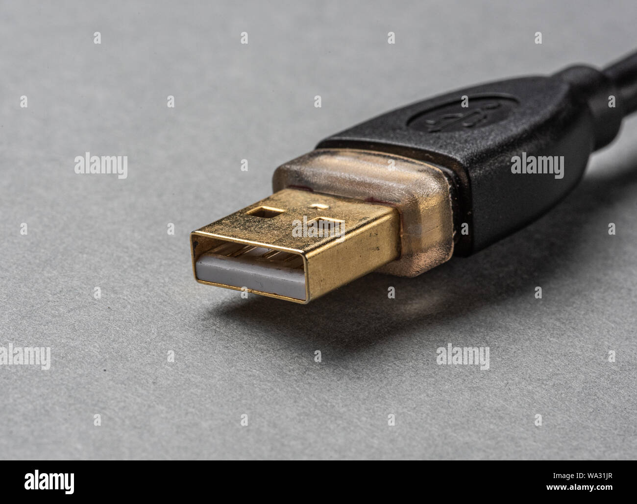 Gold USB-plug on grey background Stock Photo - Alamy